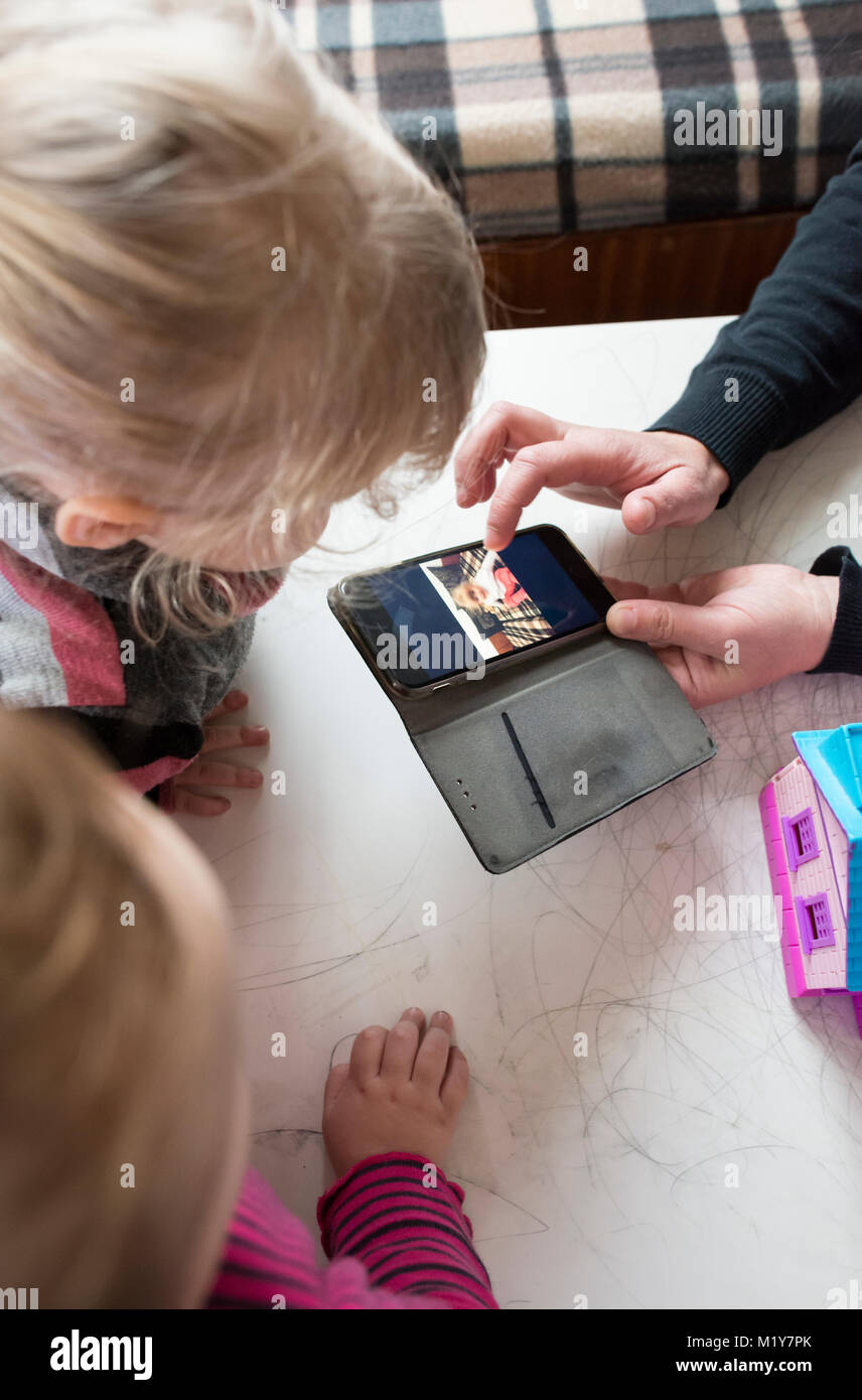 Child looking at smartphone Stock Photo - Alamy