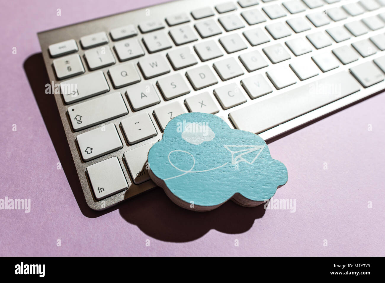 Cloud figure and keyboard on violet Stock Photo - Alamy