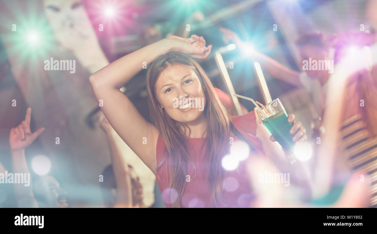 Woman dancing in the night club with drinks in the hand Stock Photo - Alamy