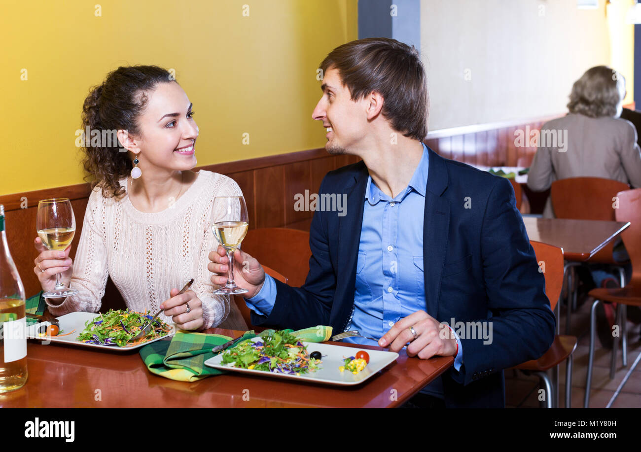 Attractive young couple having dinner at restaurant table Stock Photo ...