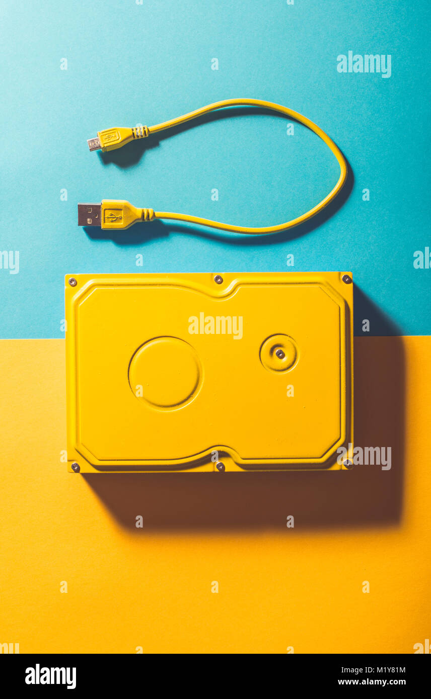 Blue colour hard disc and yellow USB cable Stock Photo - Alamy