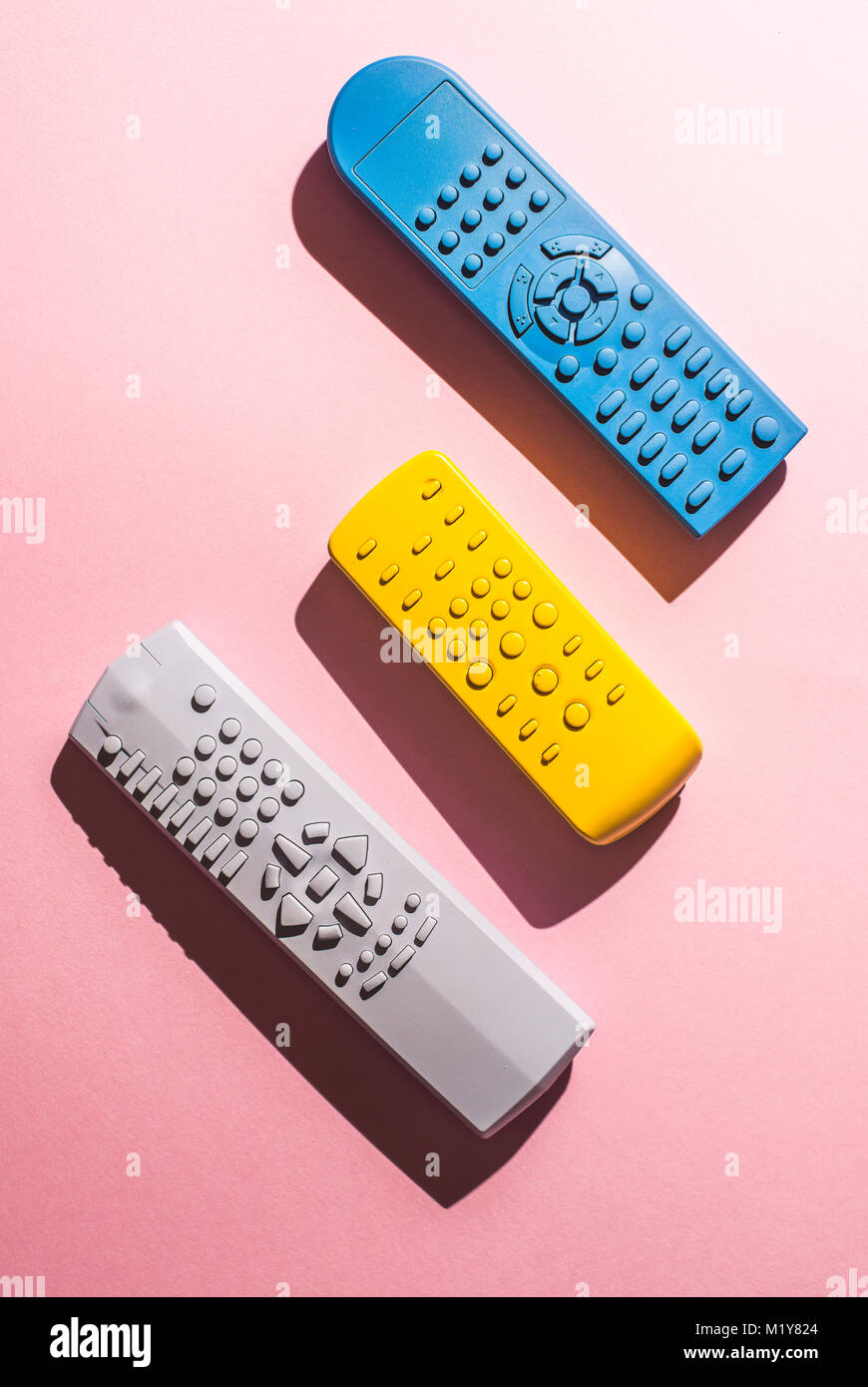 Many Colored TV remote controls on bright backgrounds Stock Photo - Alamy