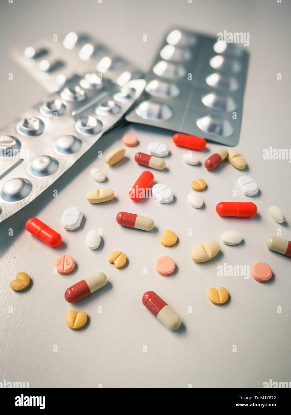 Medication white and colorful tablets arranged abstract on white color ...