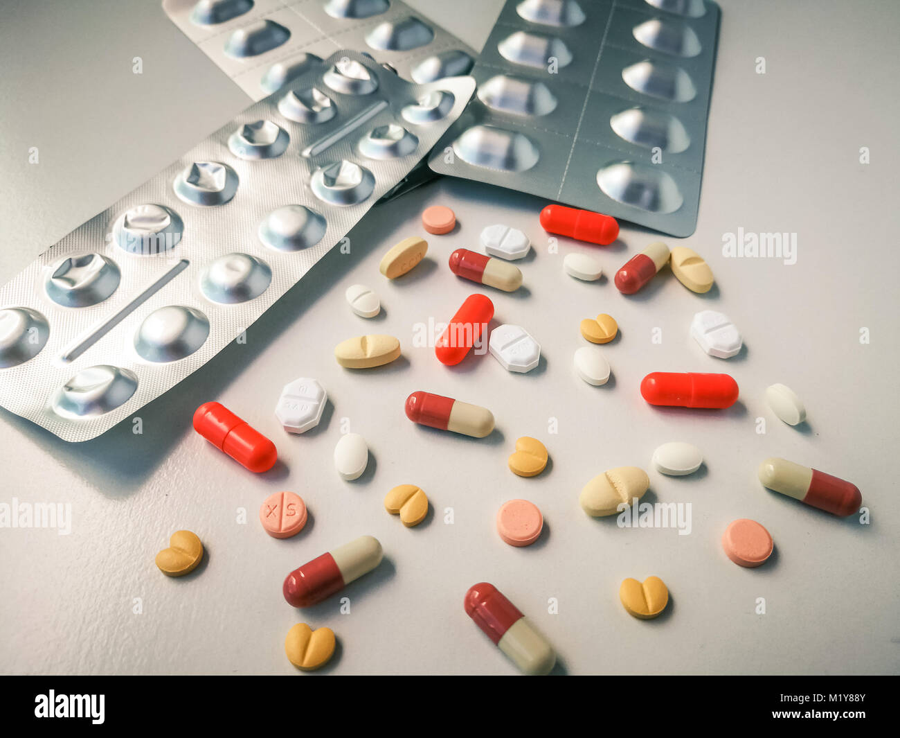 Medication white and colorful tablets arranged abstract on white color ...