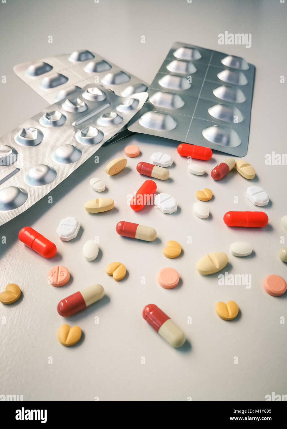 Medication white and colorful tablets arranged abstract on white color ...