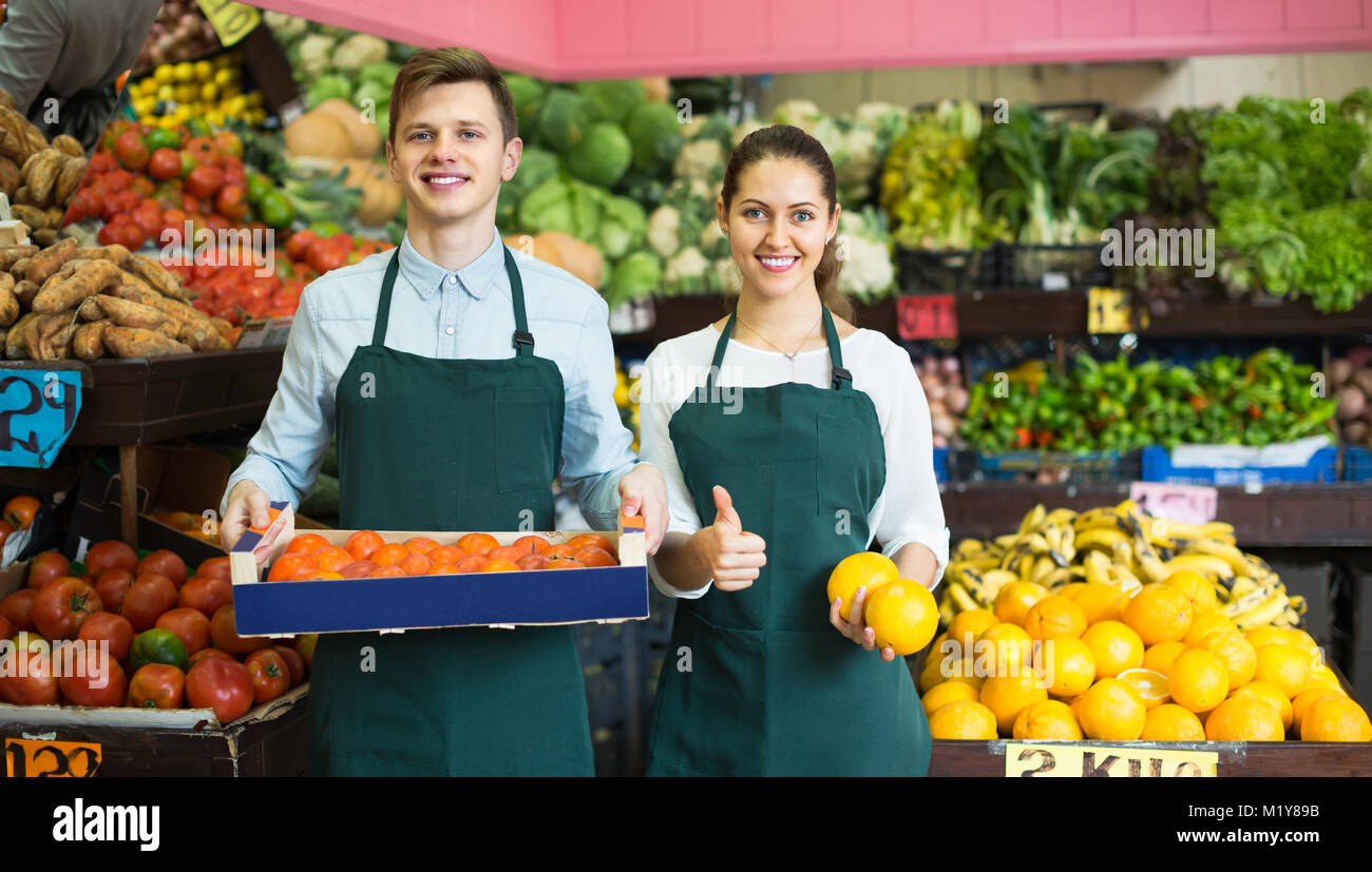 Cheerful supermarket workers in fruit and vegetables section Stock ...