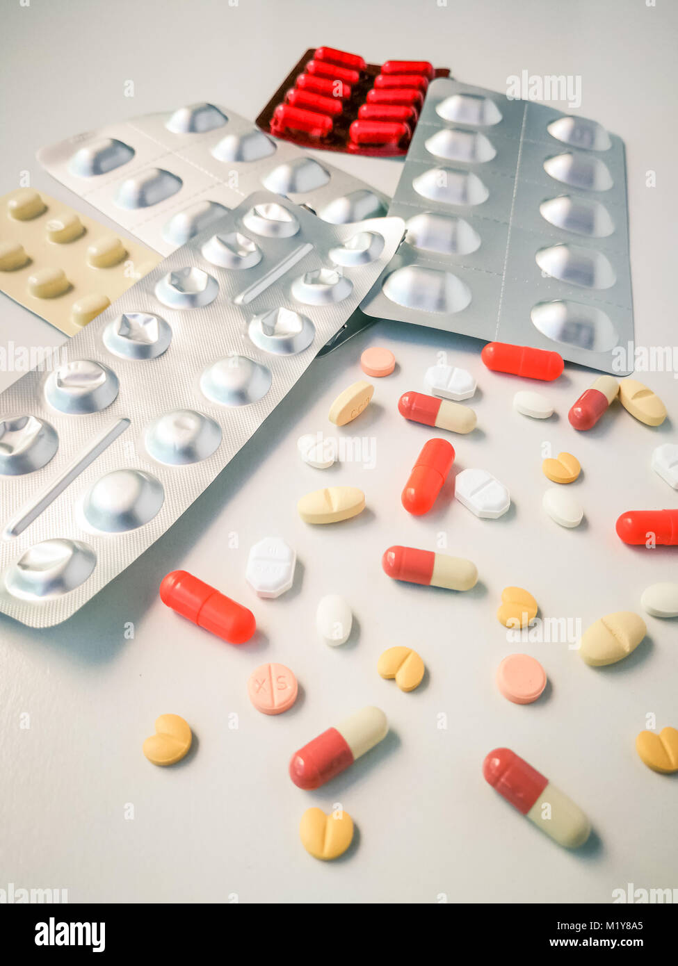 Medication white and colorful tablets arranged abstract on white color ...