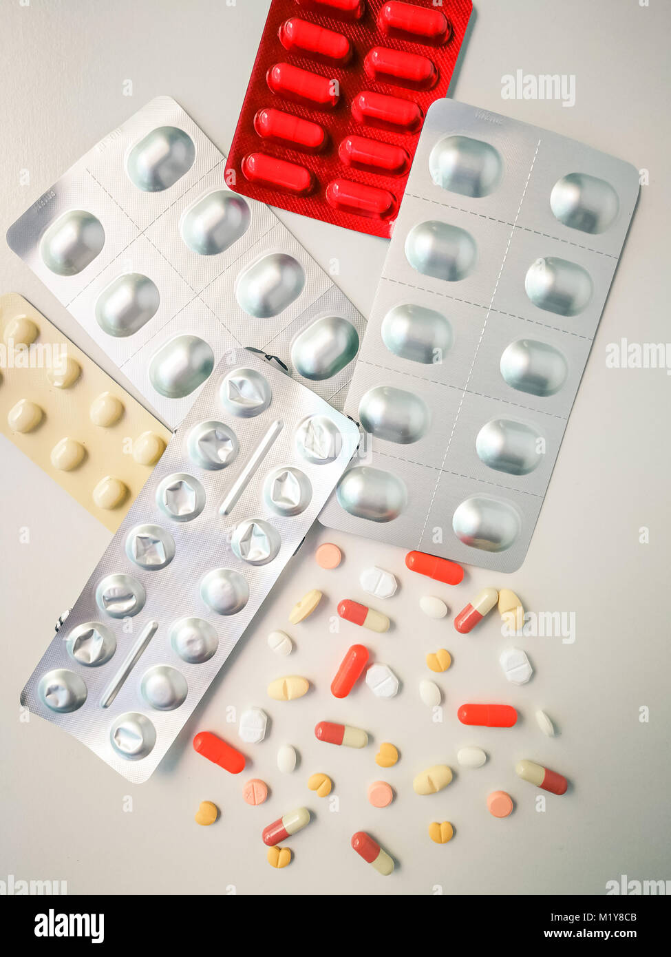 Medication white and colorful tablets arranged abstract on white color ...
