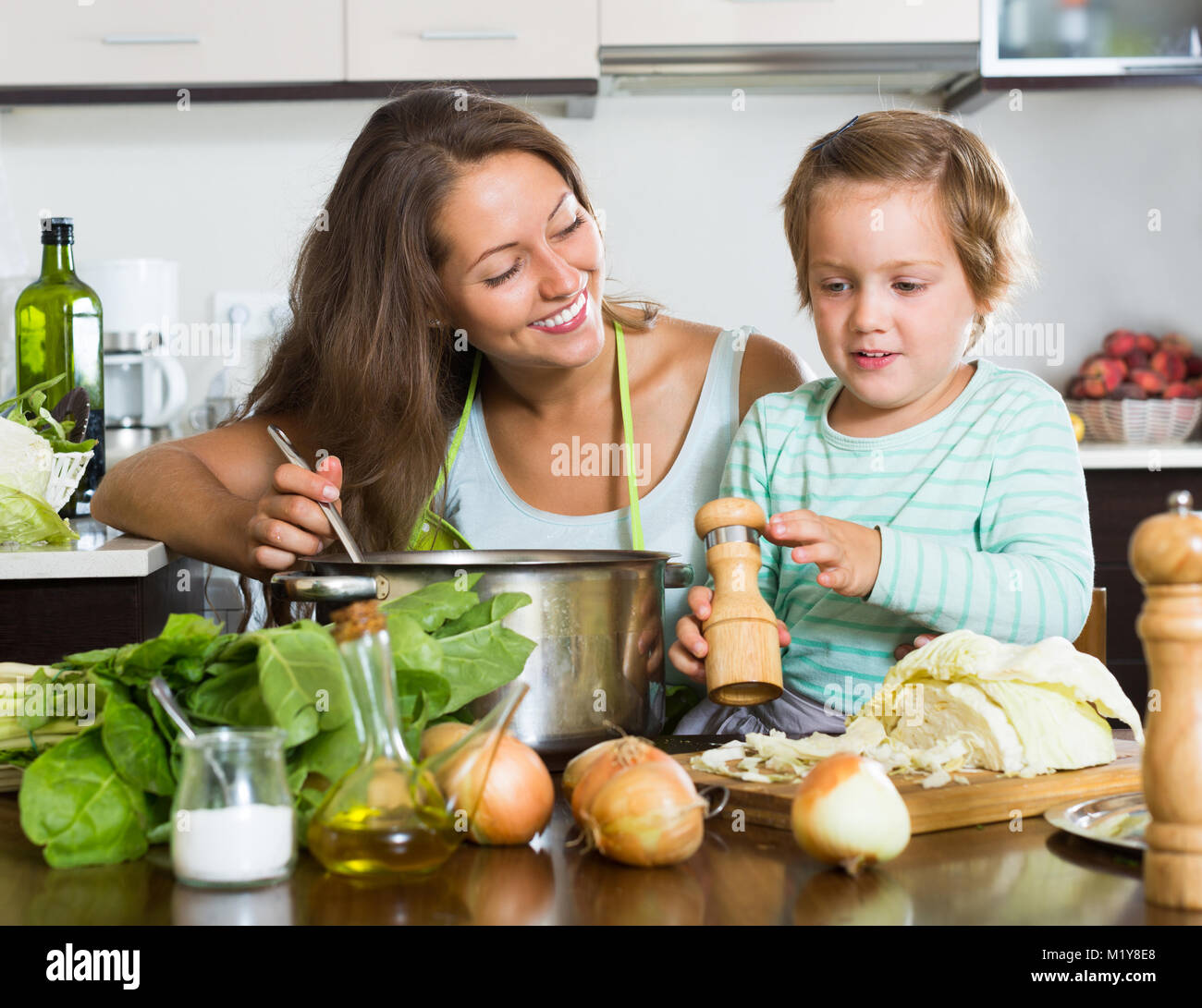 Happy family make soup at home kitchen Stock Photo - Alamy