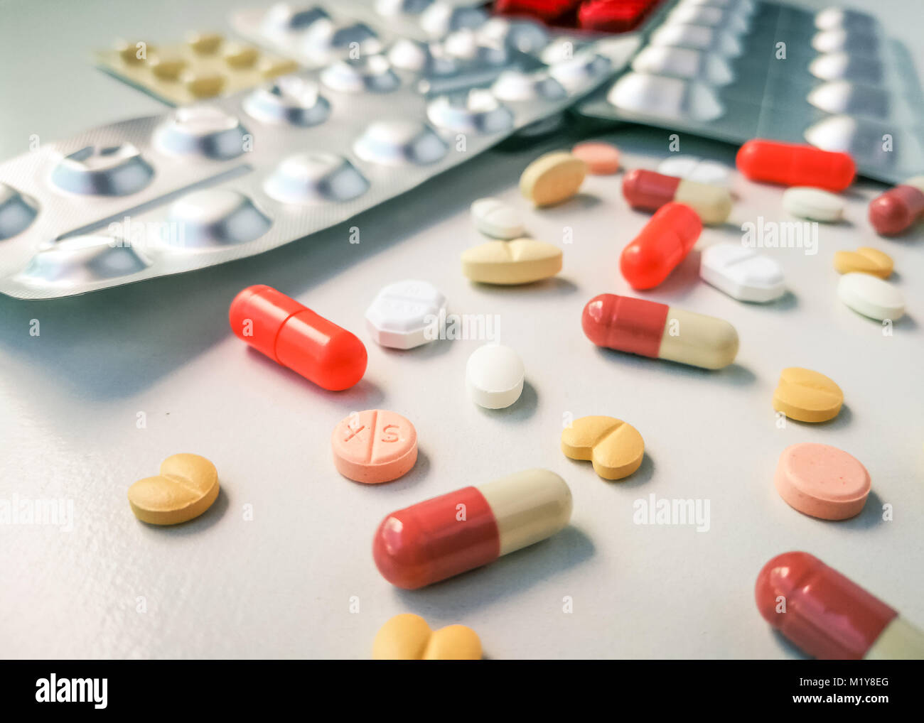 Medication white and colorful tablets arranged abstract on white color ...