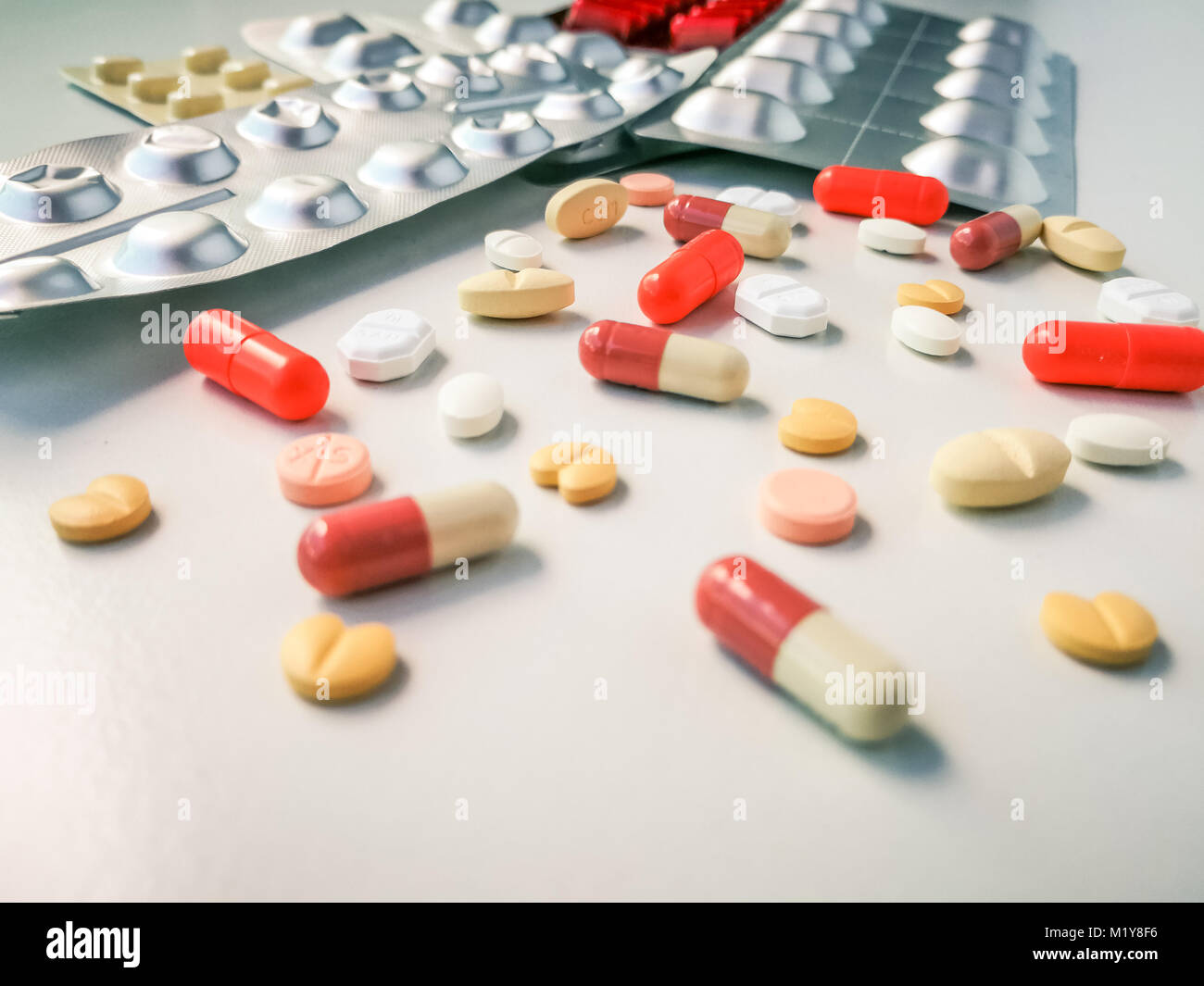 Medication white and colorful tablets arranged abstract on white color ...