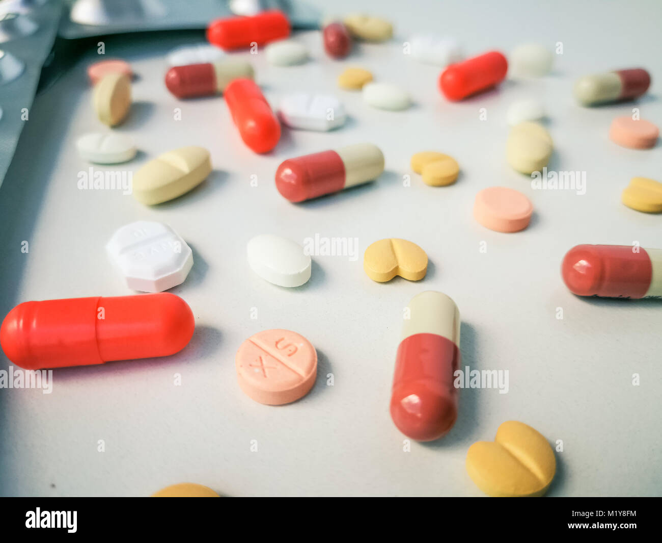 Medication white and colorful tablets arranged abstract on white color ...