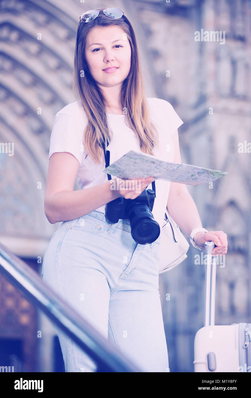 Beautiful traveling girl searching for direction using paper map in the ...