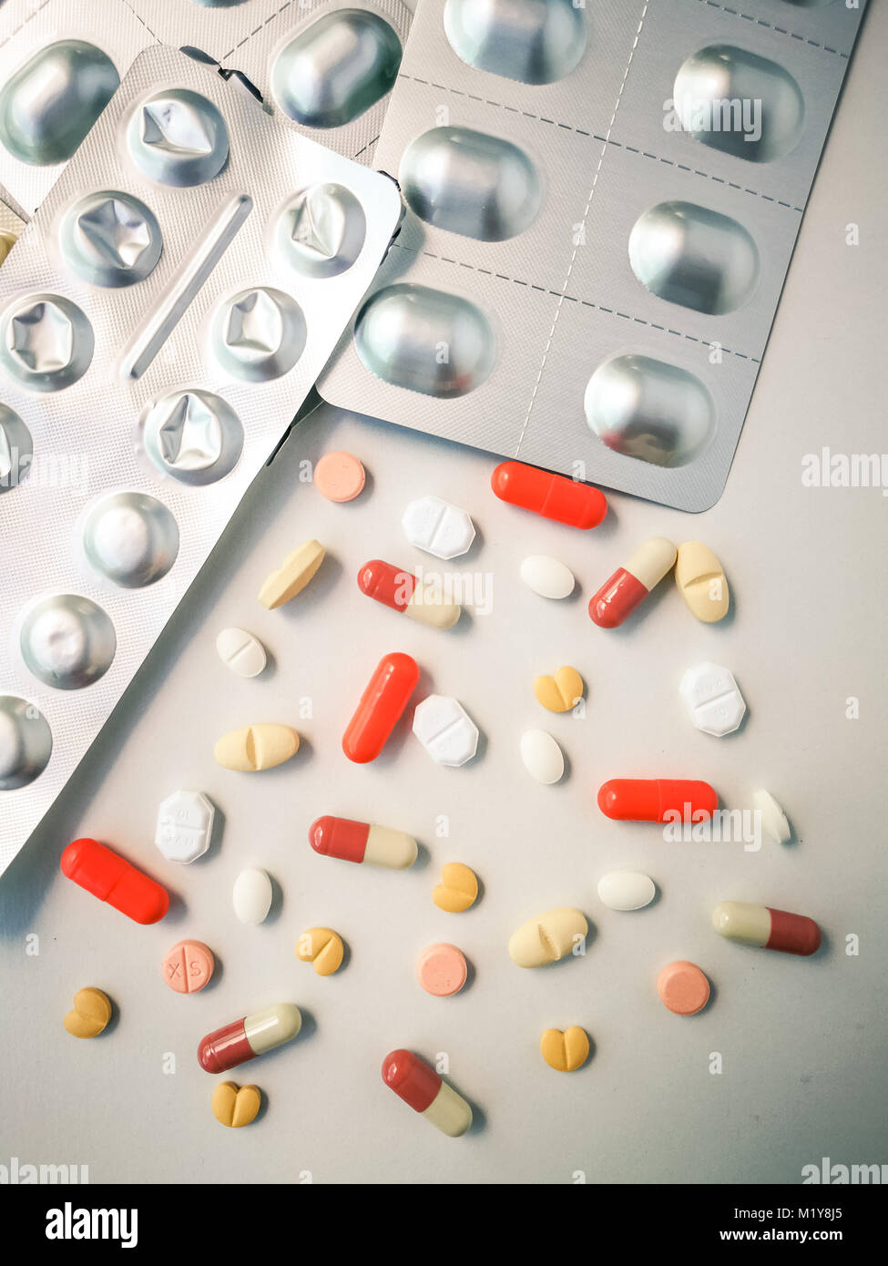 Medication white and colorful tablets arranged abstract on white color ...