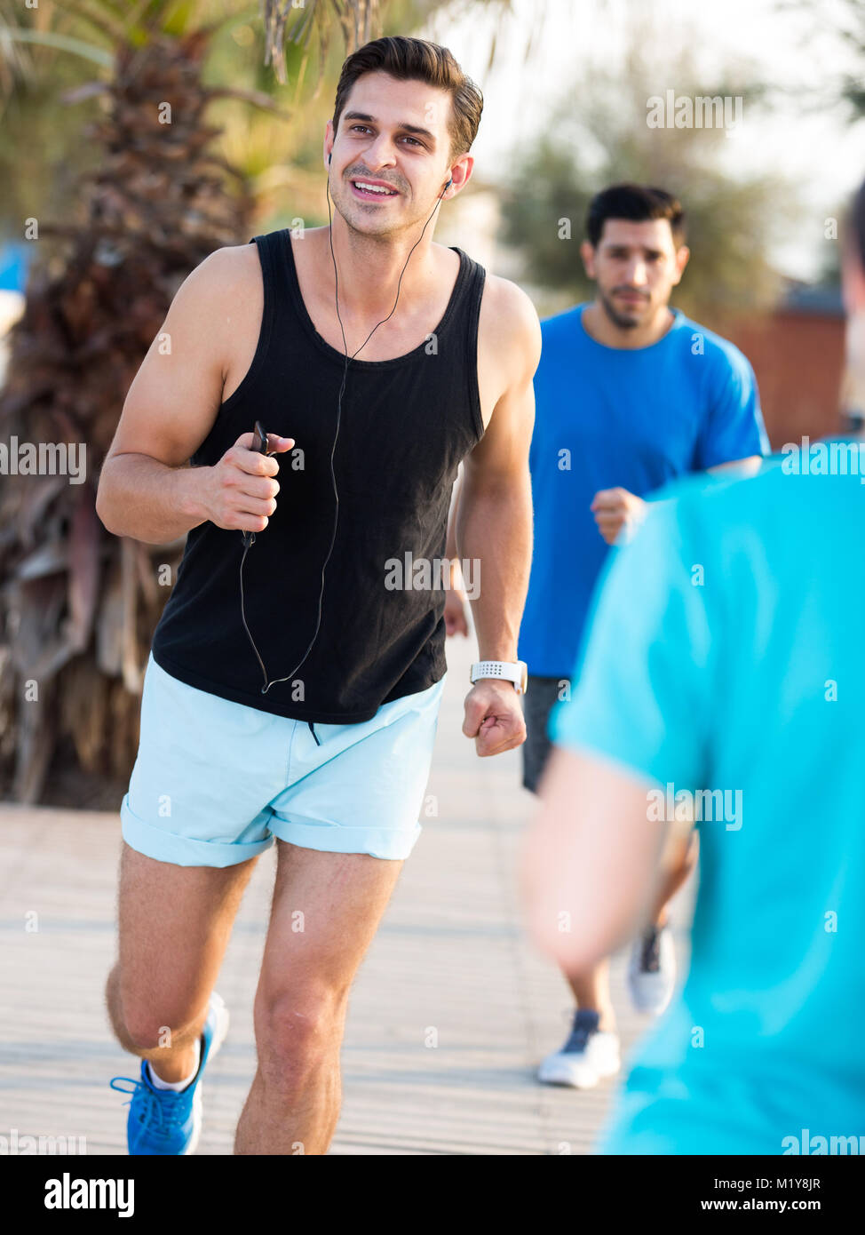 Two friends are doing race in time training in the park near sea Stock ...