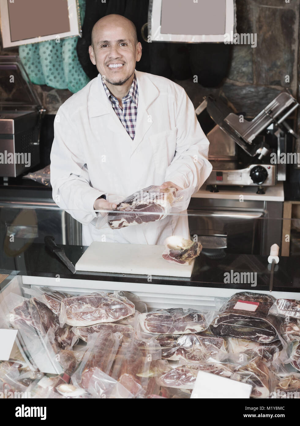Male person with wurst and jamon in meat store counter Stock Photo - Alamy