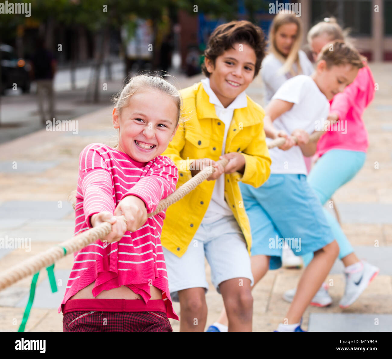 Children are pulling rope in the park Stock Photo - Alamy