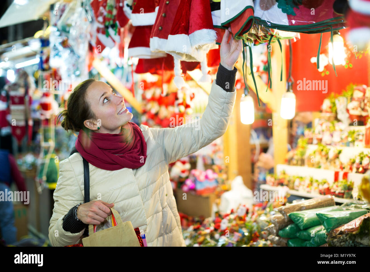 Portrait of attractive female customer near counter with Christmas ...