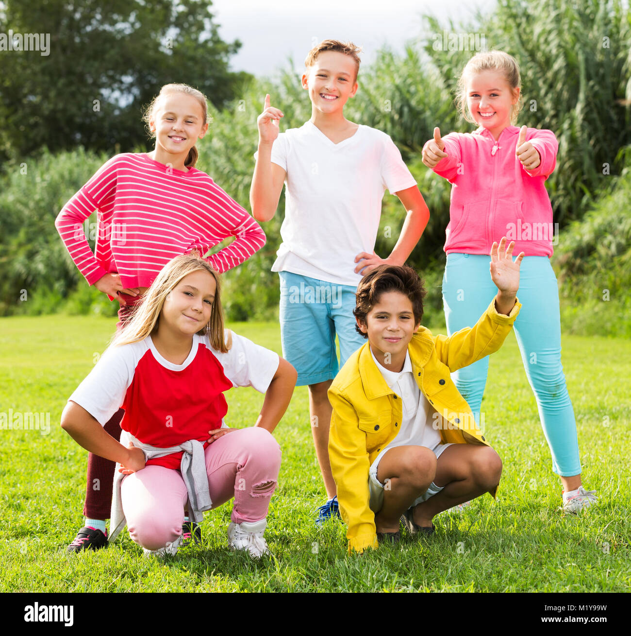 Portrait of five smiling children who are walking and posing in the ...