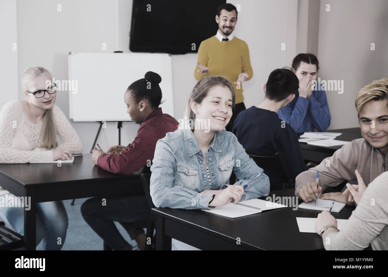 Teenage girls and boys are working in large groups in school Stock ...