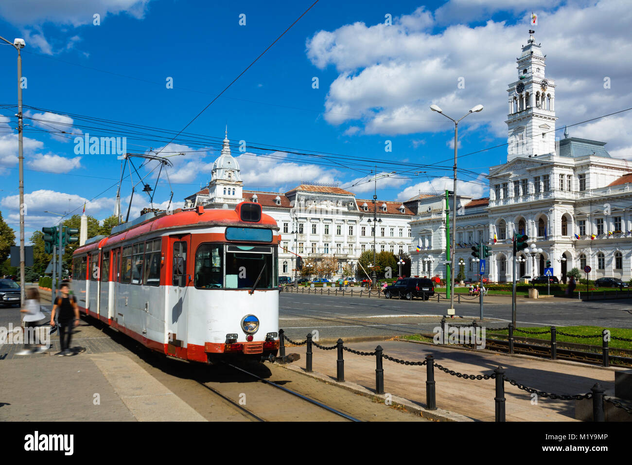 Colored trams running on main square near Arad city hall, Romania Stock ...