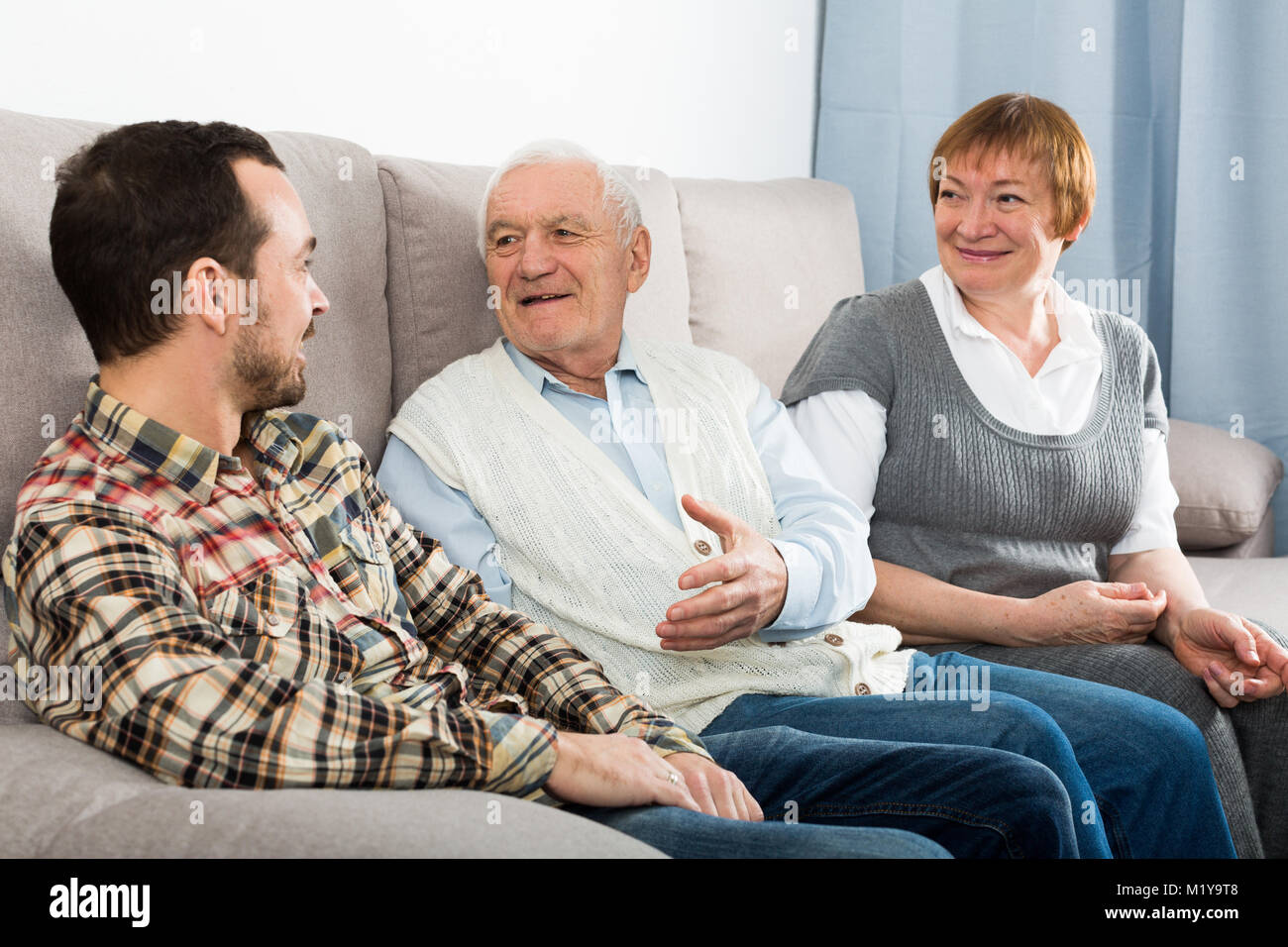 Mature mother and father and son happy to spend time together at home ...