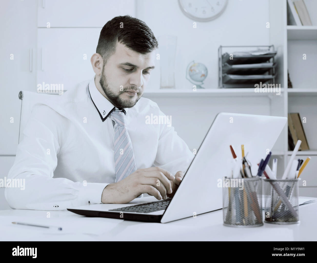Smiling man worker working effectively on project in office Stock Photo ...