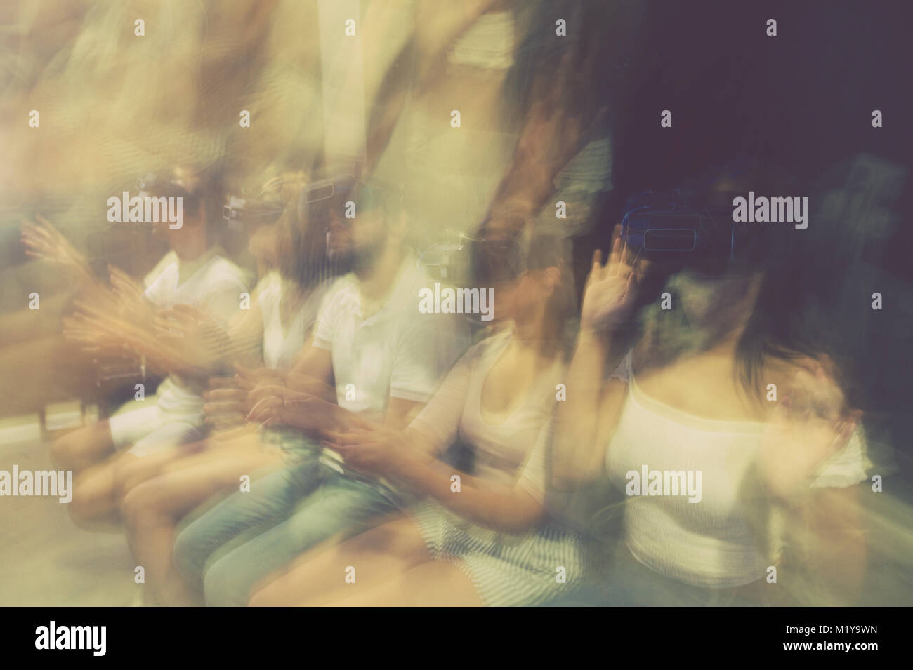 Motion blur of people having fun with new technology vr headset goggles ...