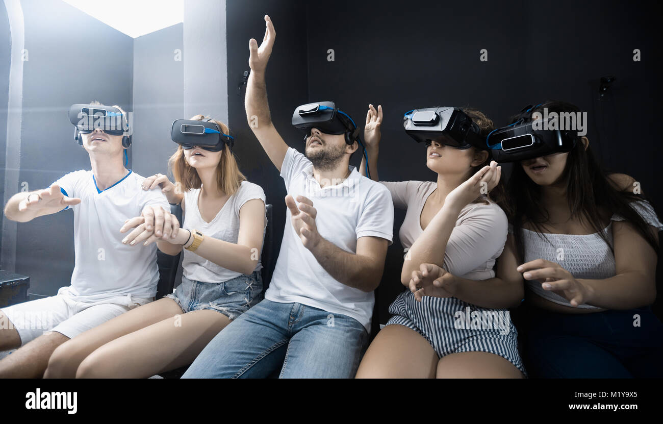 portrait of young people getting experience using virtual reality ...