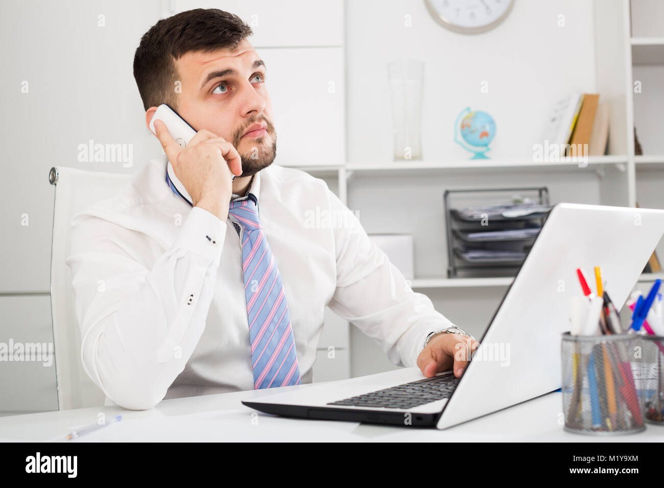 Smiling man worker working effectively on project in office Stock Photo ...