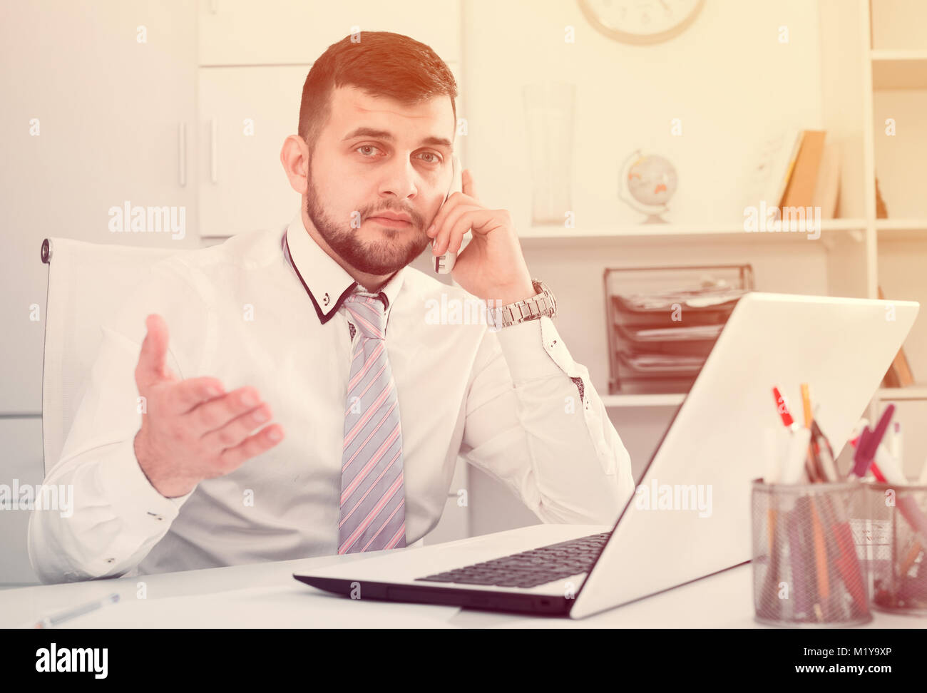 Smiling man worker working effectively on project in office Stock Photo ...
