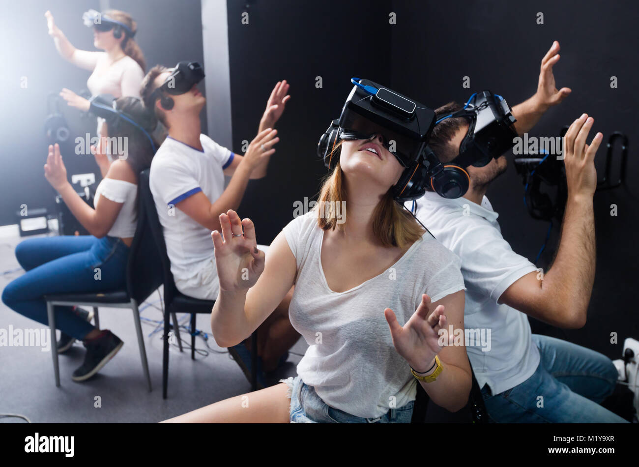 Young happy people having fun with the new technology vr headset ...