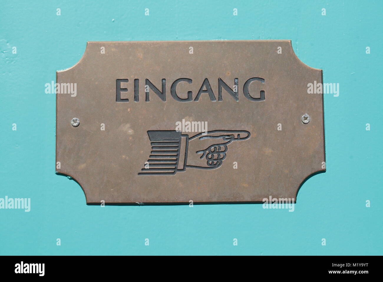 metal entrance sign with a hand (Eingang in german Stock Photo - Alamy