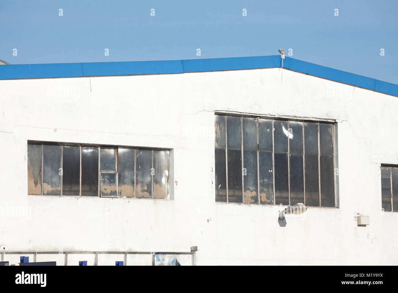 old windows on an old factory scale with blue sky Stock Photo - Alamy