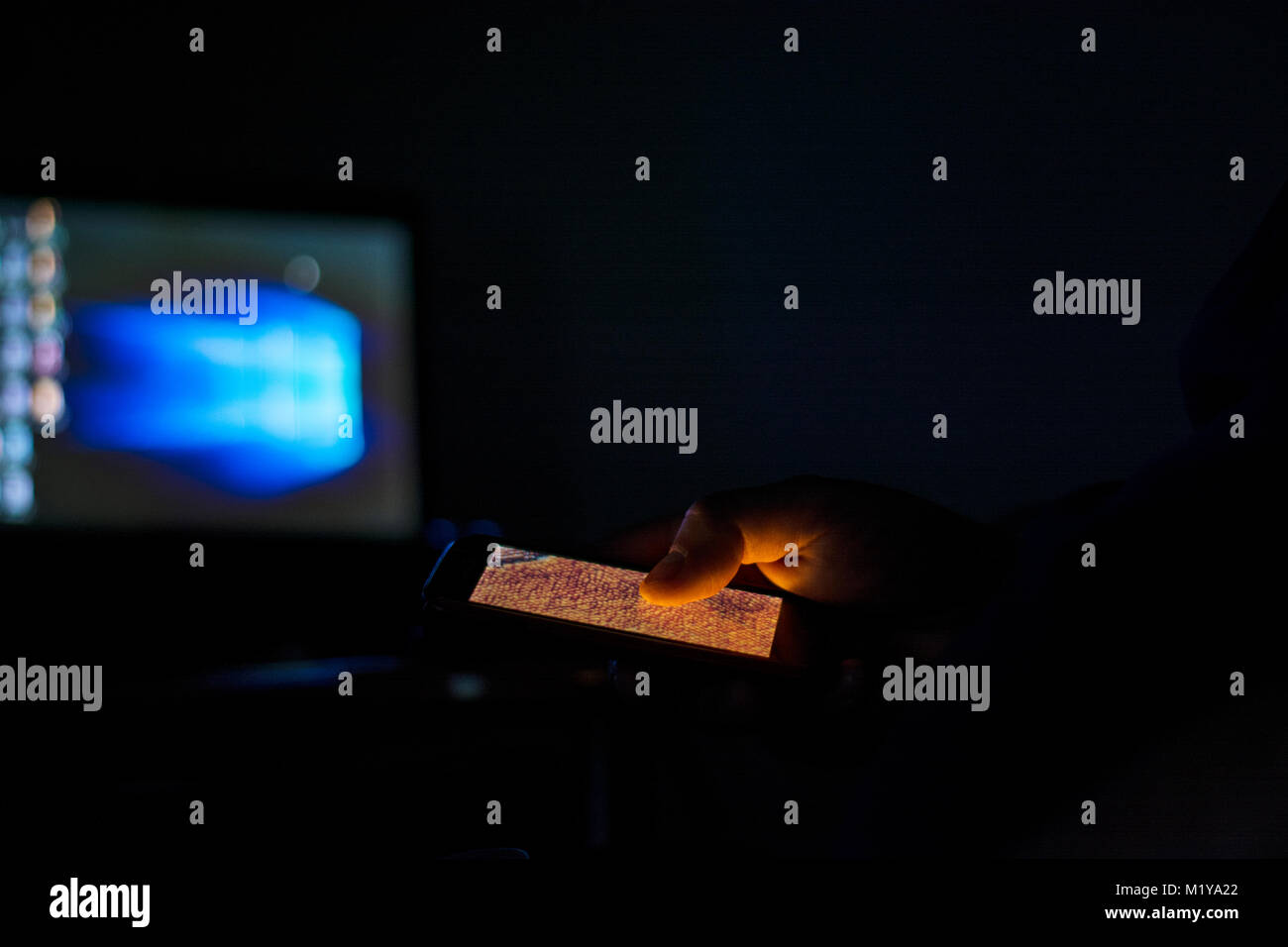 Working late on a mobile phone in a dark room Stock Photo - Alamy