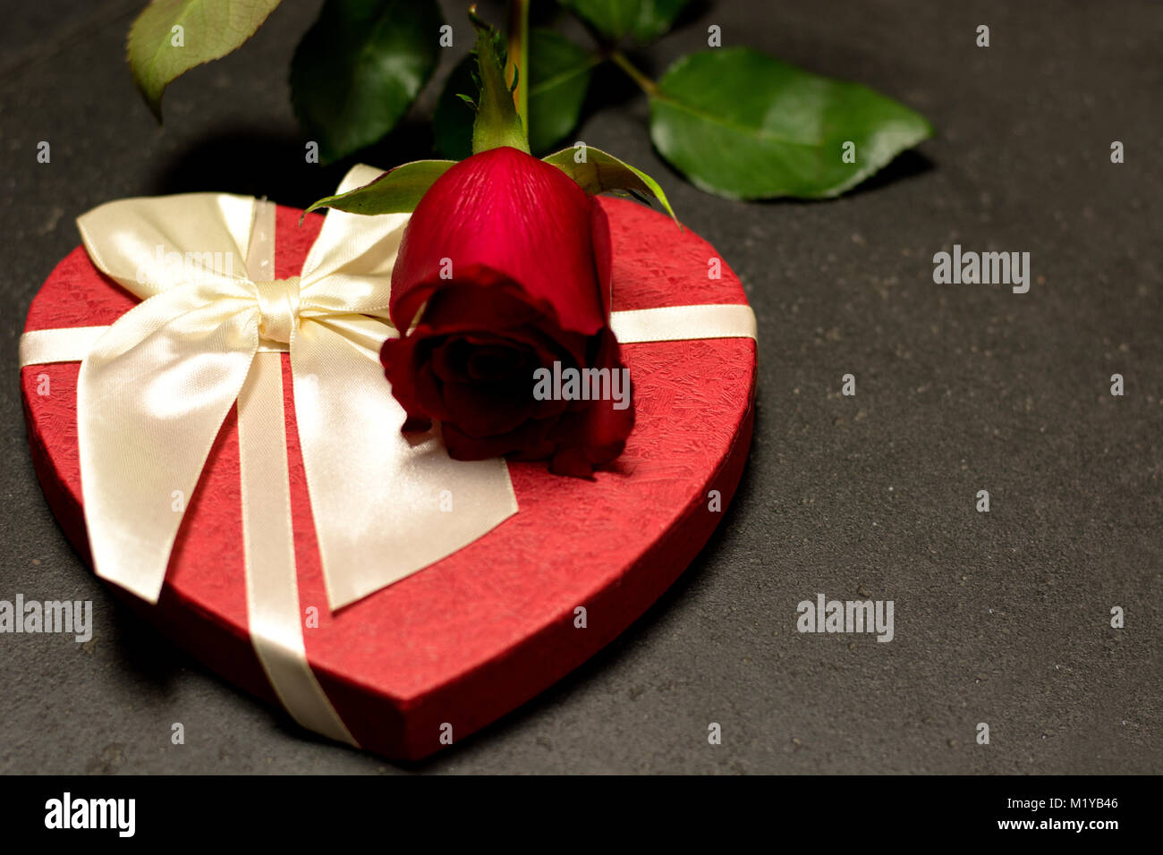 Red heart shape box with red rose Stock Photo - Alamy