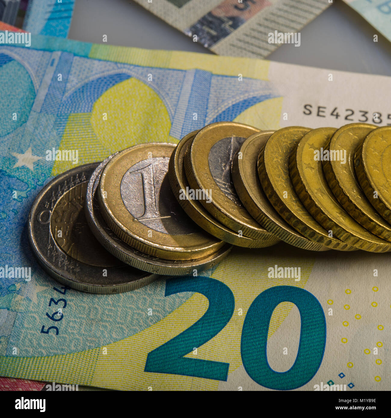 paper euro banknotes and coins. The coin is one euro. Currency of the ...