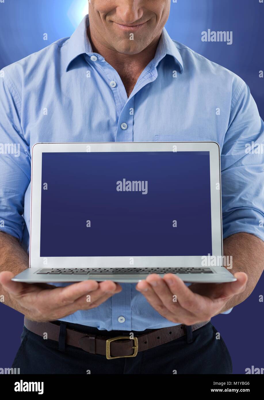 Hand holding laptop with blue background Stock Photo - Alamy