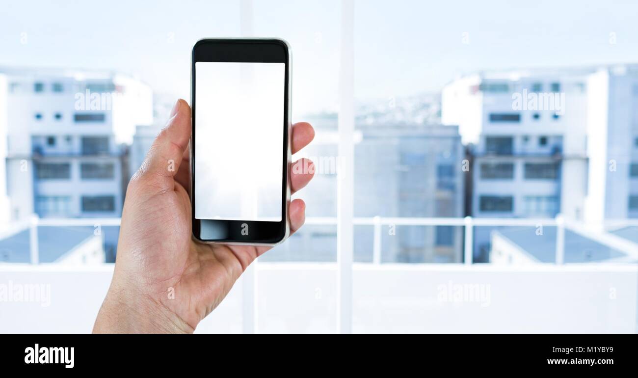 Hand holding phone with city window Stock Photo - Alamy