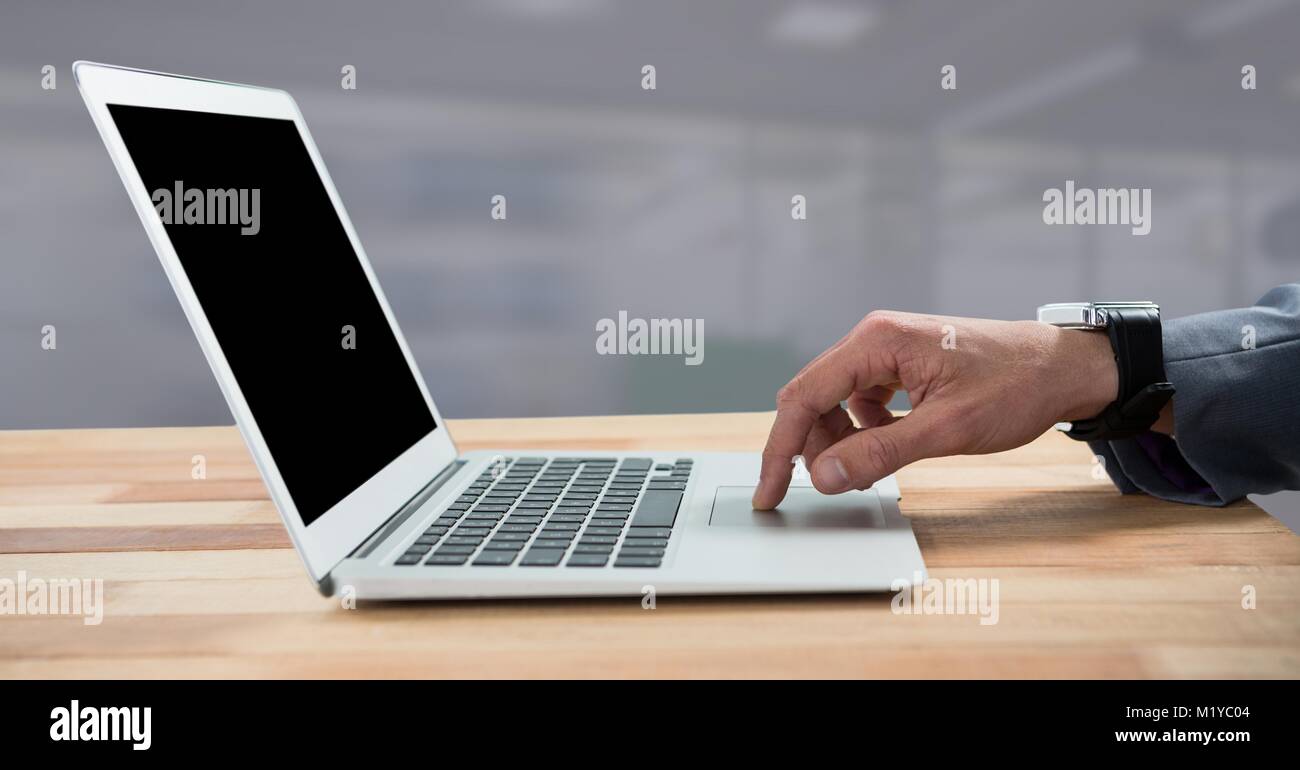 Hand using laptop with desk Stock Photo - Alamy