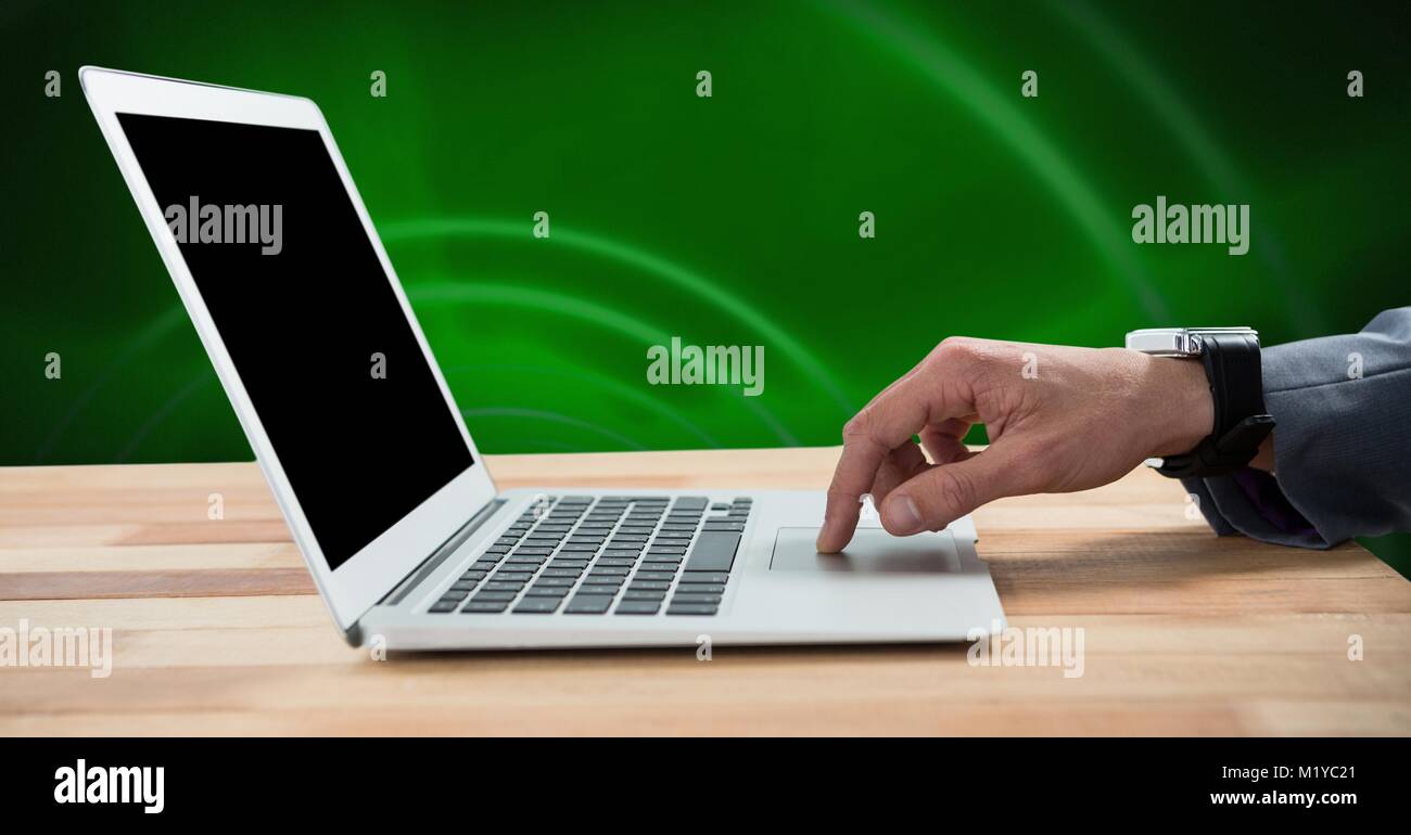 Hand using laptop on desk Stock Photo - Alamy