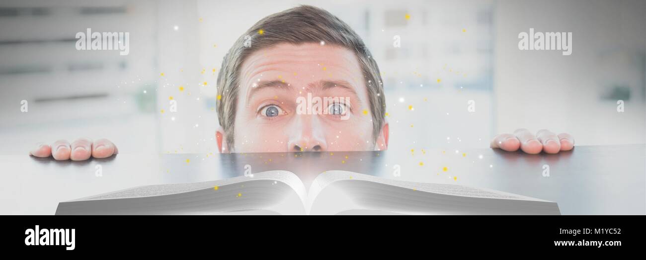 Man looking at an opened book with lights on a table Stock Photo - Alamy