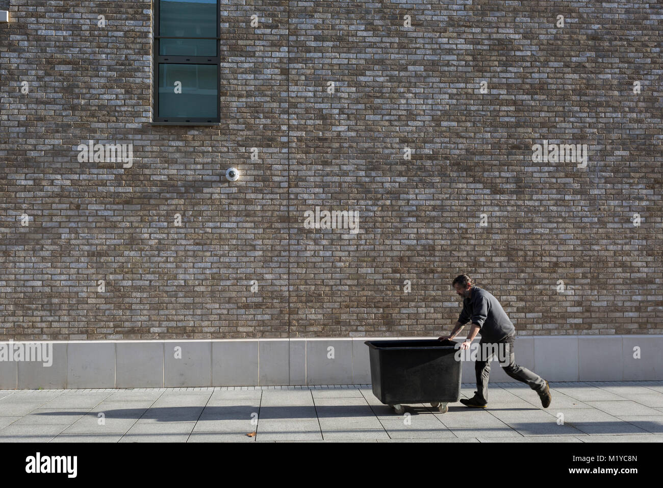 Pushing a bin hi-res stock photography and images - Alamy