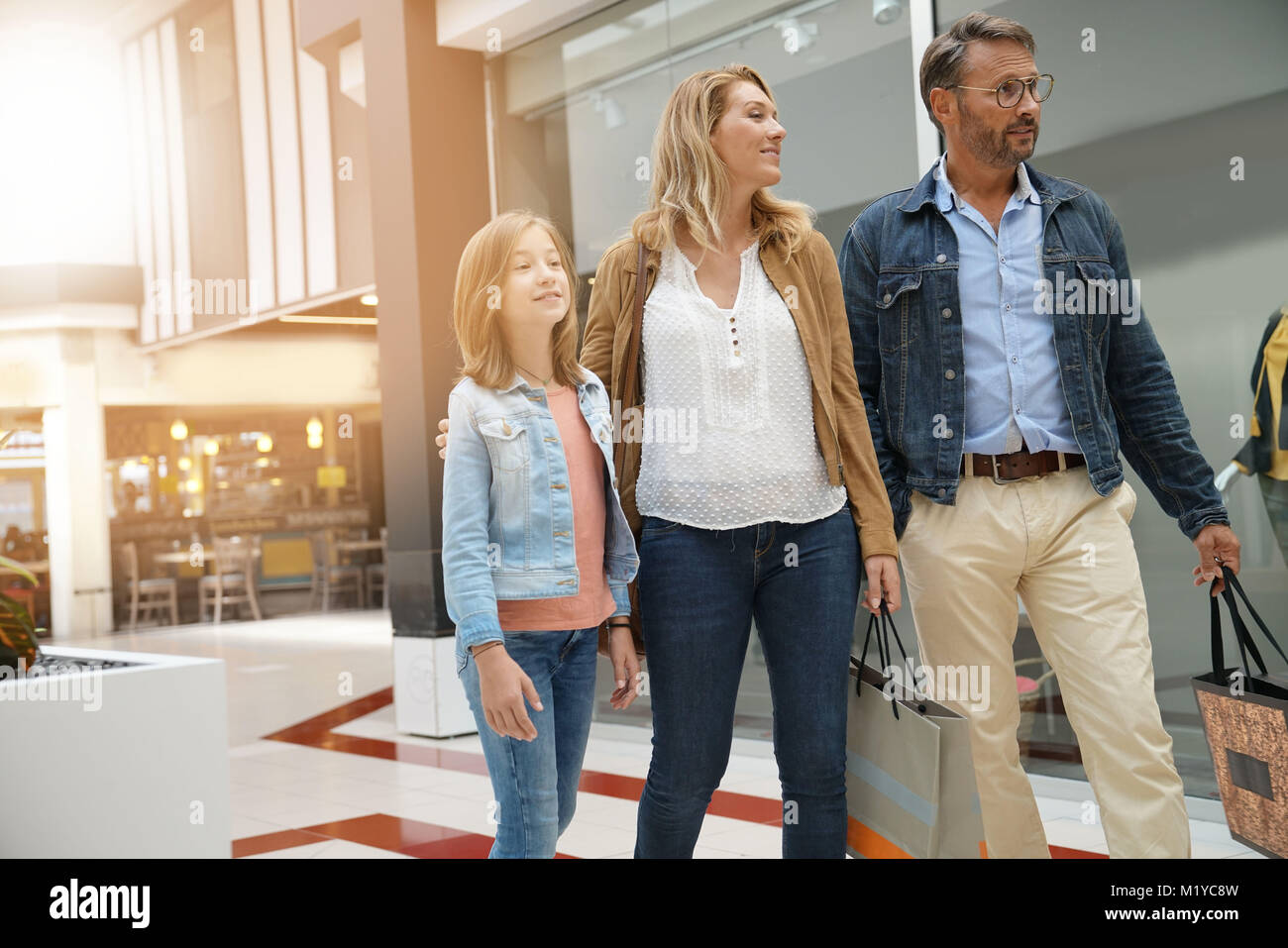 Family on shopping day walking in mall Stock Photo - Alamy
