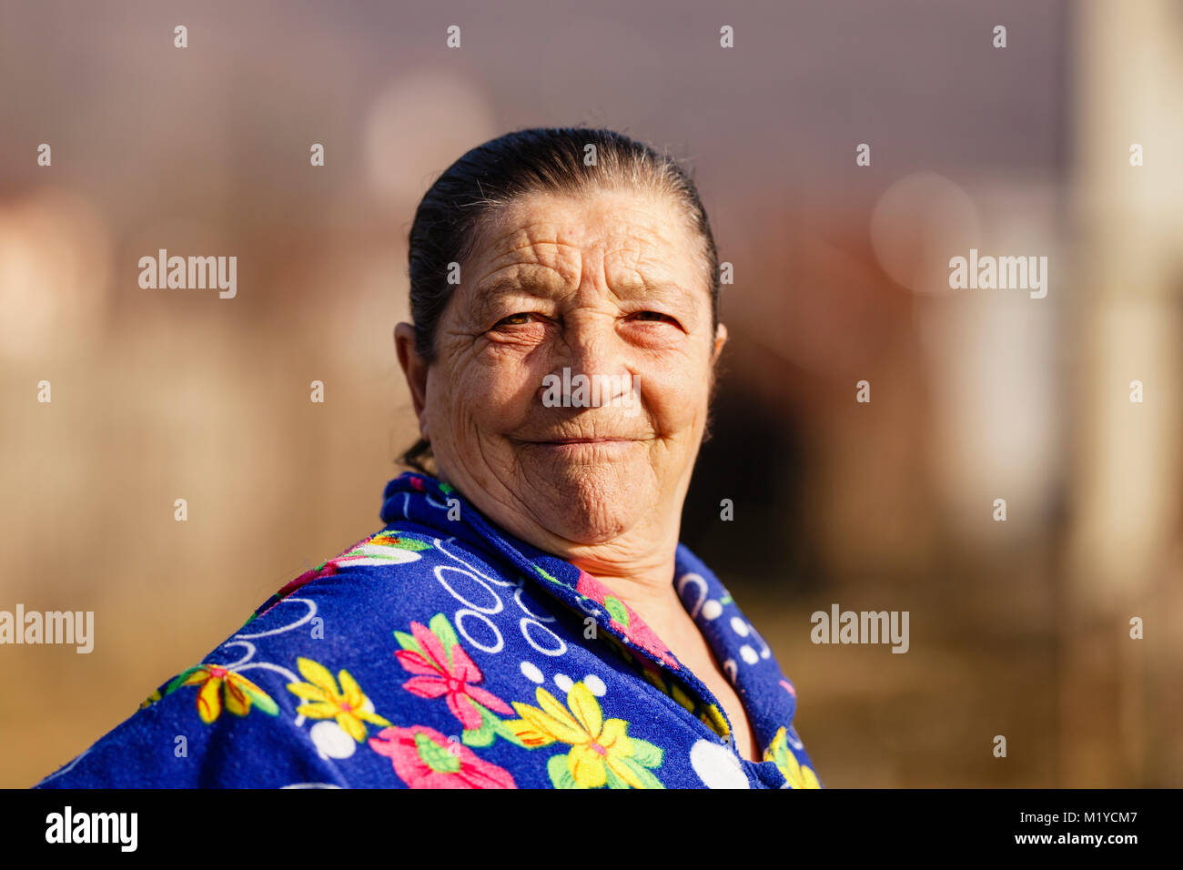 Old woman outdoor in her backyard, closeup portrait Stock Photo - Alamy