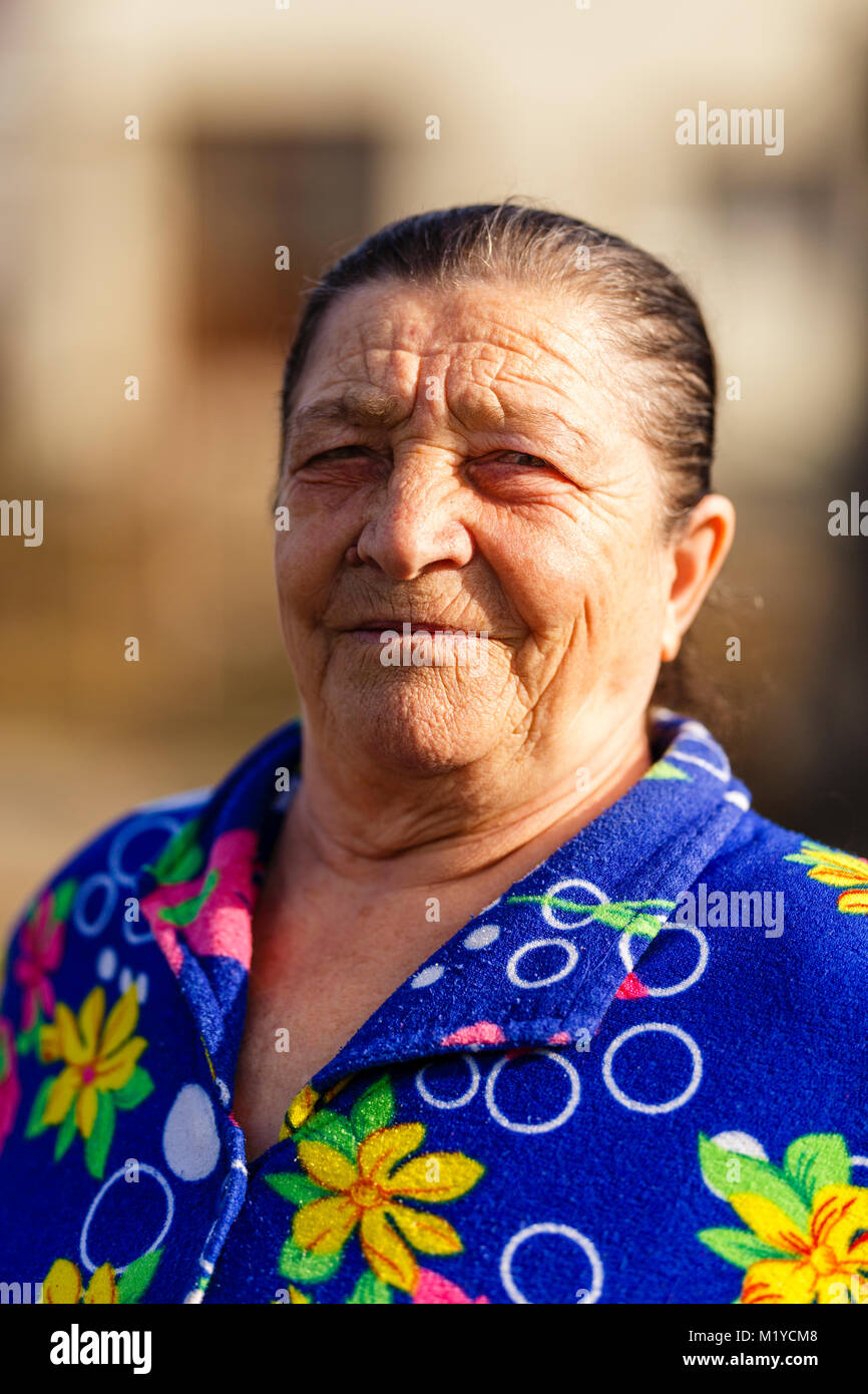 Old woman outdoor in her backyard, closeup portrait Stock Photo - Alamy