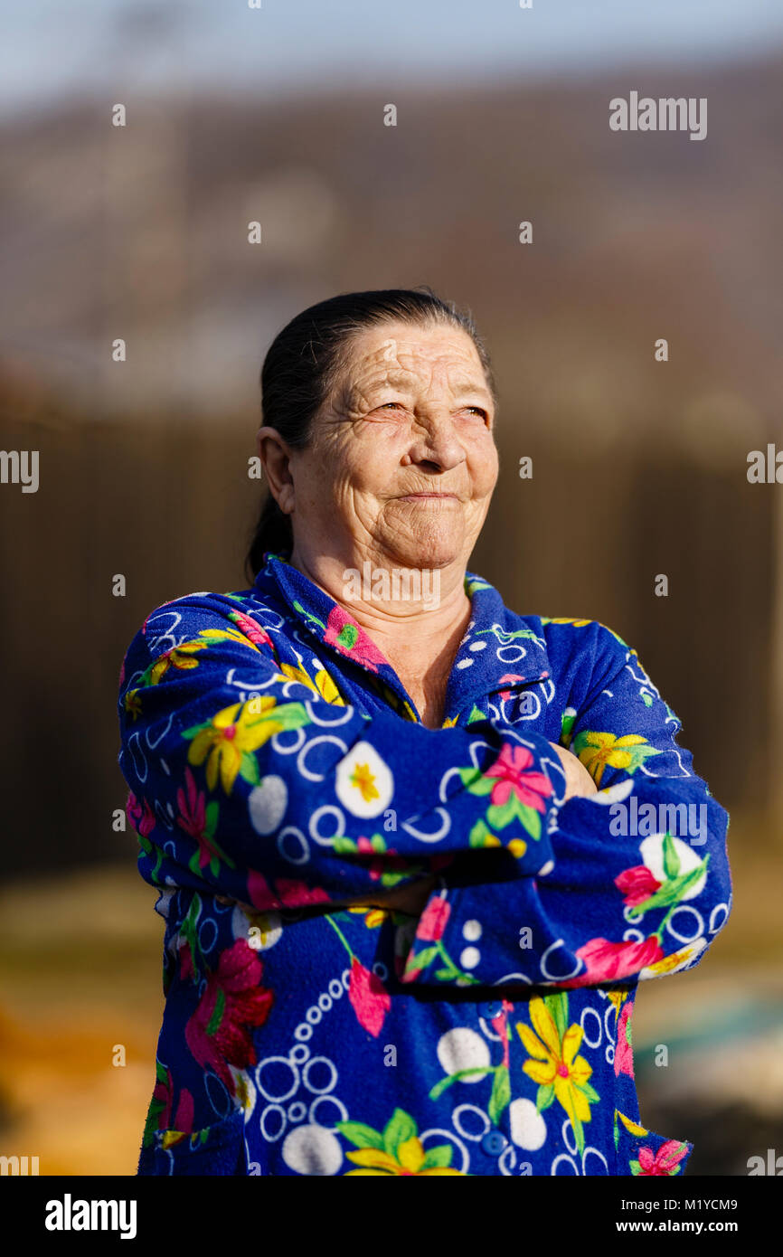 Old woman outdoor in her backyard, closeup portrait Stock Photo - Alamy