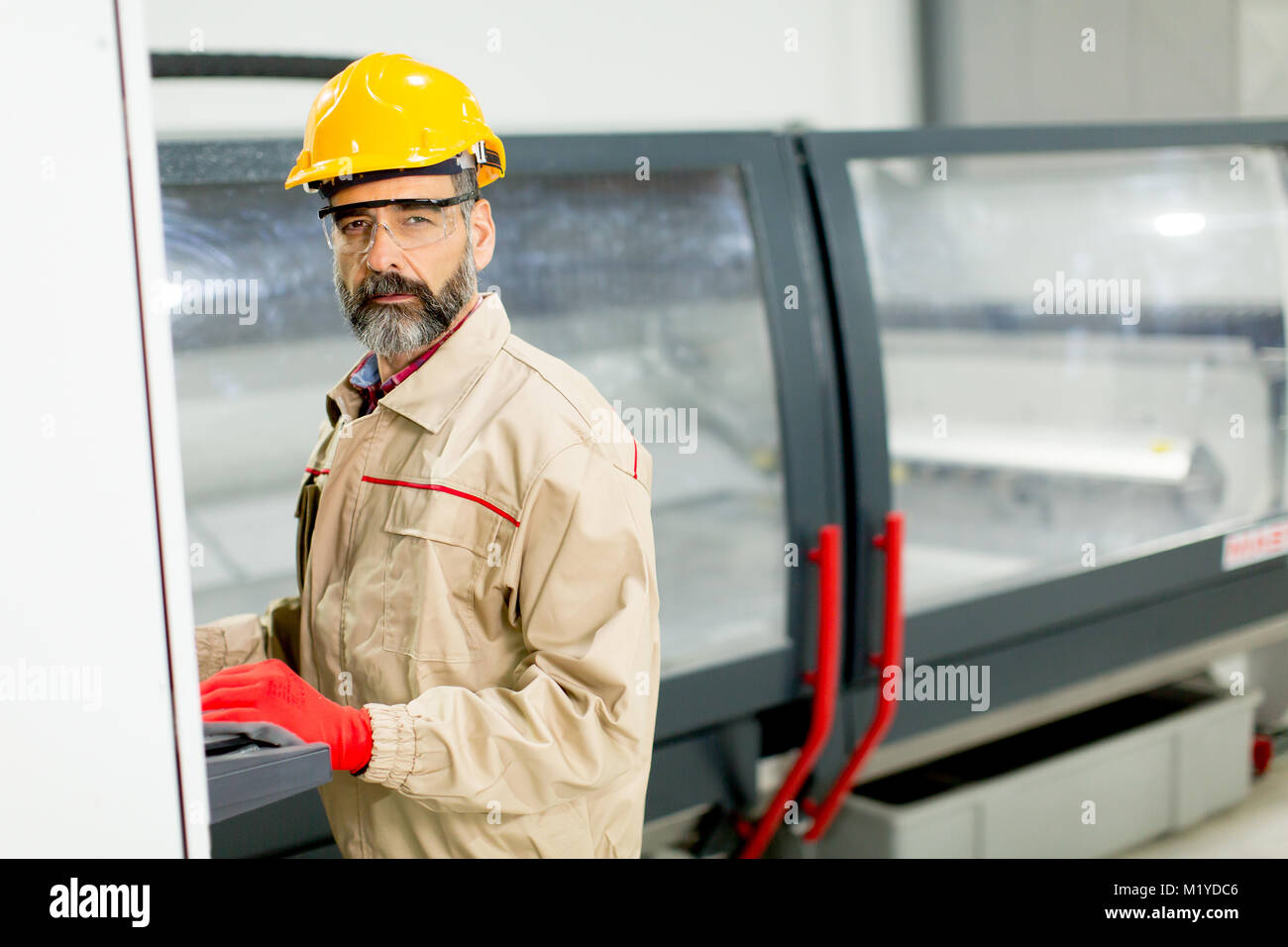View at senior man working in factory Stock Photo - Alamy