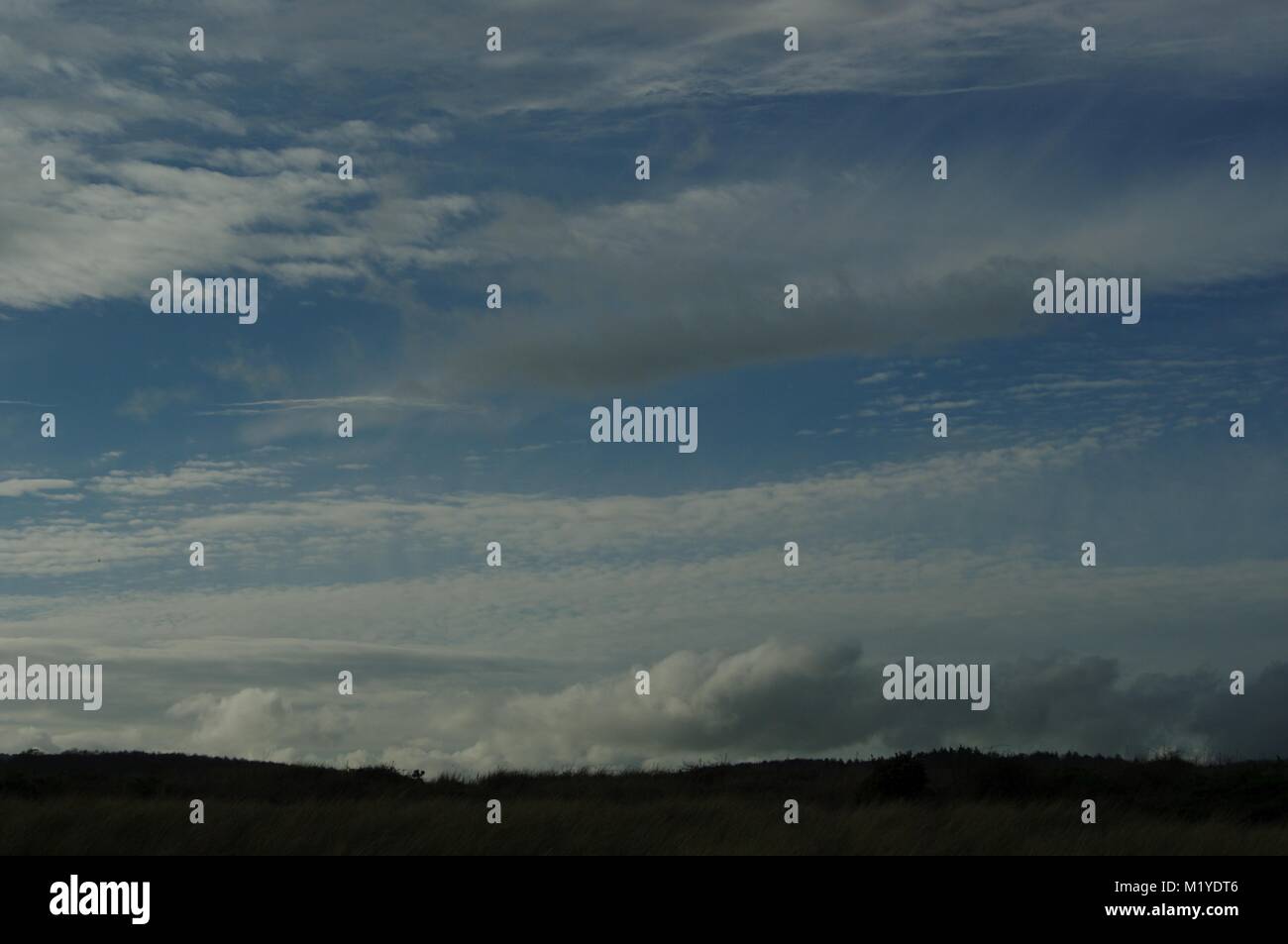 Weak Sun Shines through Maceral Altocumulus Clouds in a Spooky Abstract, Dark yet Glowing Effect ...