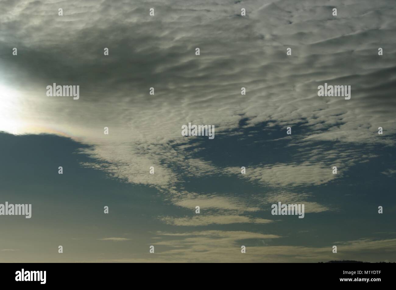 Weak Sun Shines through Maceral Altocumulus Clouds in a Spooky Abstract, Dark yet Glowing Effect ...